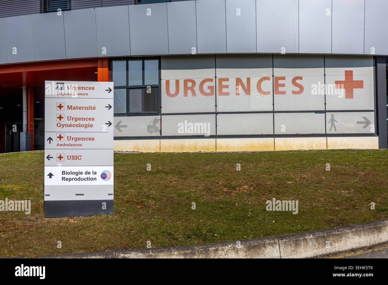 The exterior of a medical facility with a directional sign and a ...