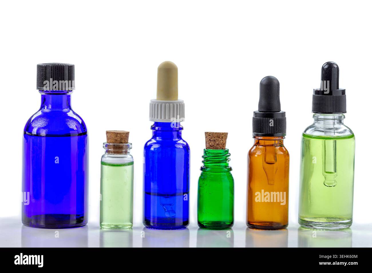Six glass bottles of varying sizes, colors, and closures, including ...