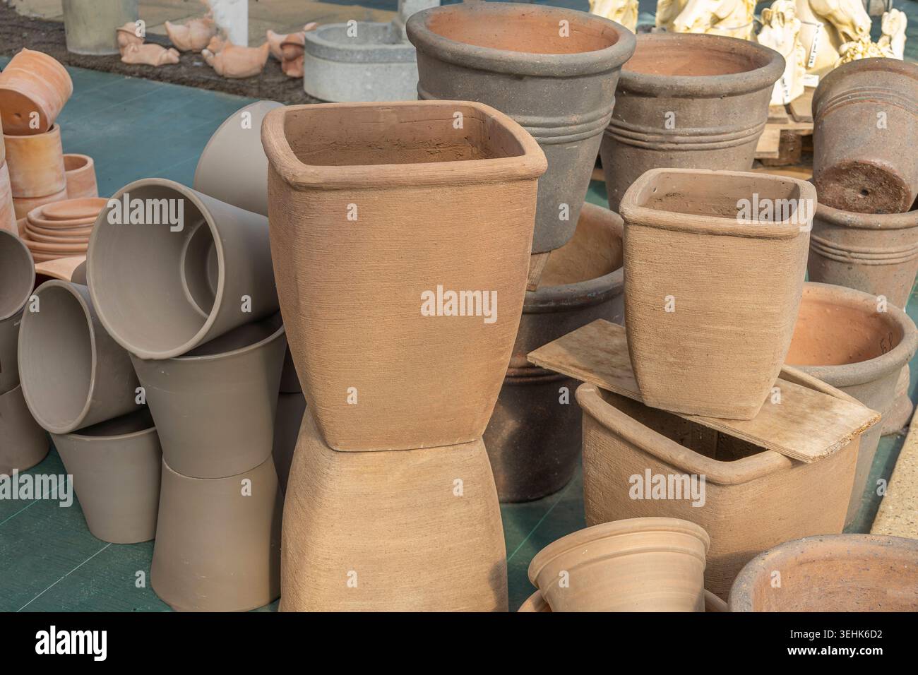 A collection of clay pots in various shapes, sizes, and colors are ...