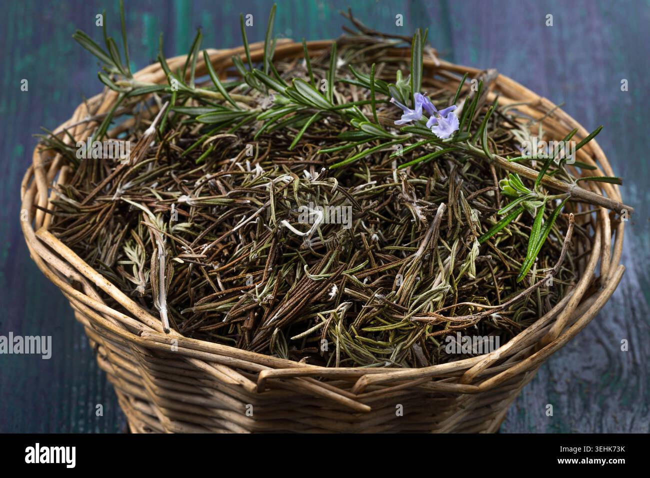 A wicker basket contains dried and fresh rosemary Salvia rosmarinus ...