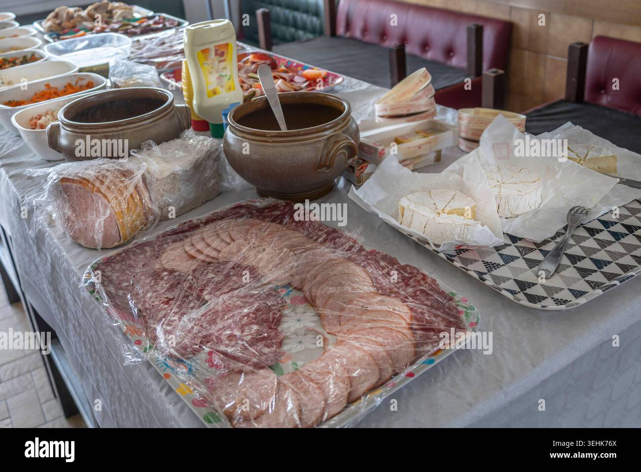 A table covered with a white cloth holds various foods, including ...