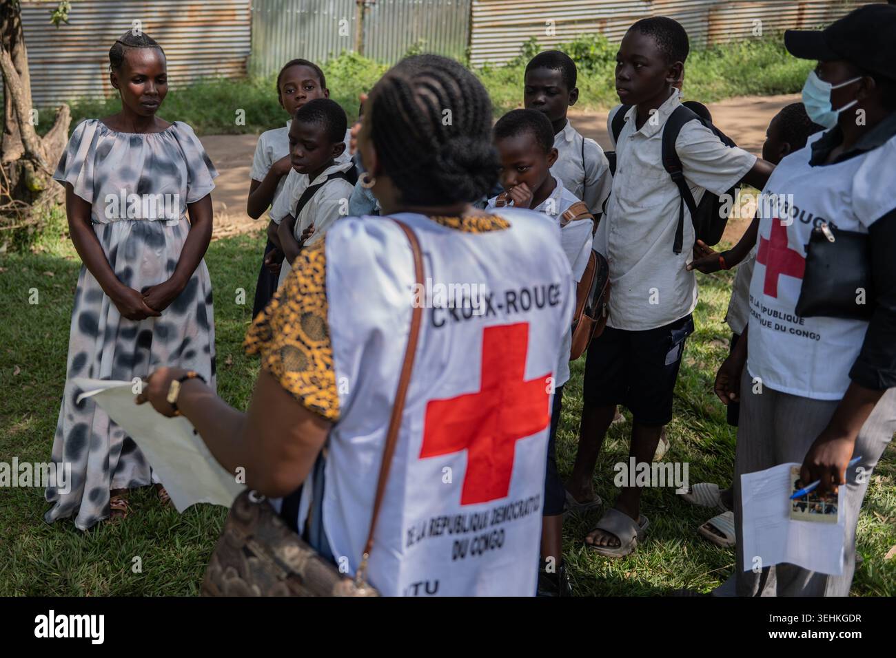 Vanny Birungi, a Red Cross volunteer, speaks to people during a house ...