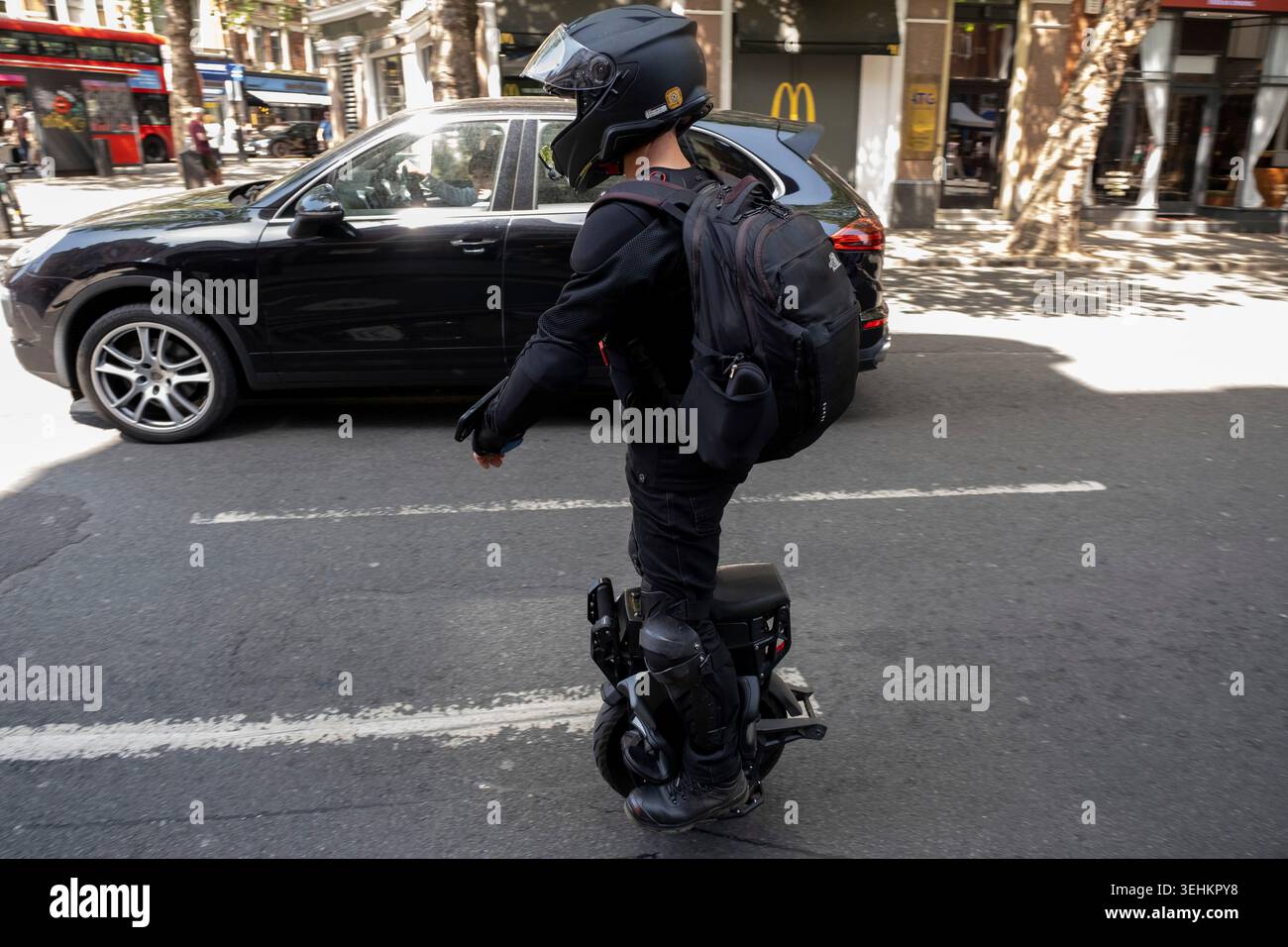 Man passes on a self-balanced e-scooter on 24th May 2026 in London ...