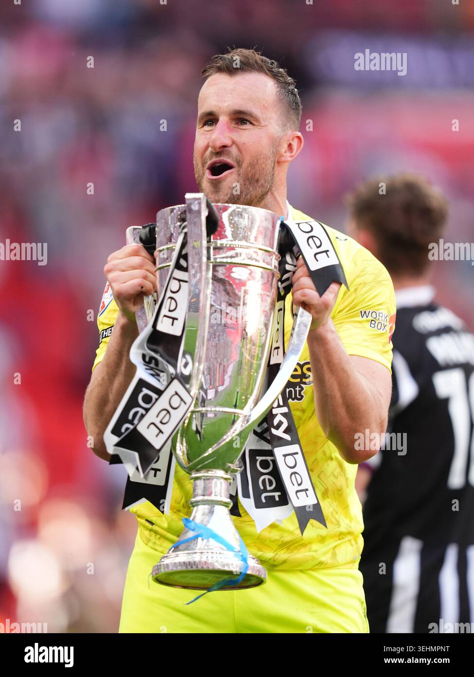 Notts County goalkeeper James Belshaw celebrates with the trophy ...