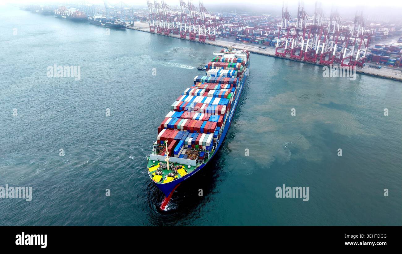 A cargo ship leaves the berth after completing foreign trade container ...