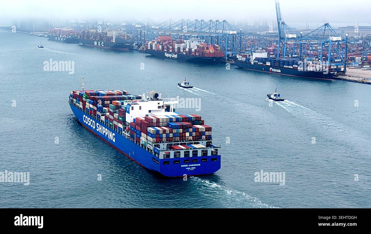 A cargo ship leaves the berth after completing foreign trade container ...