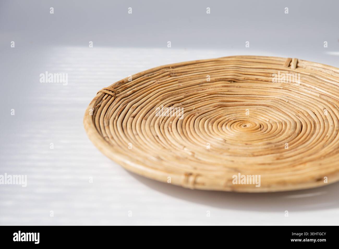 Empty round wicker tray on white background with natural handmade ...