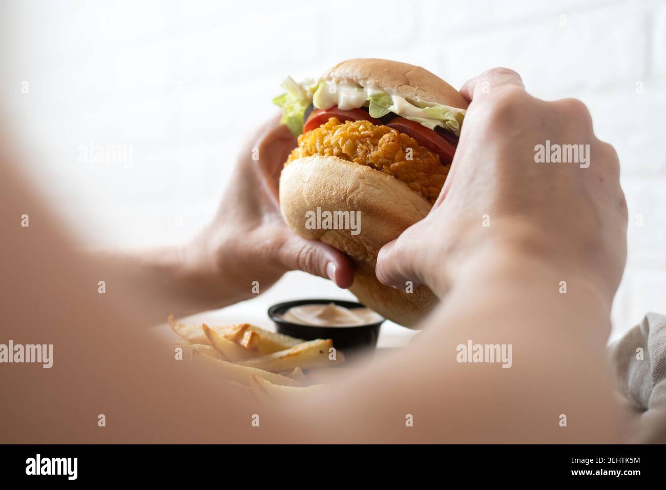 Woman holding crispy chicken burger ready to eat Stock Photo - Alamy