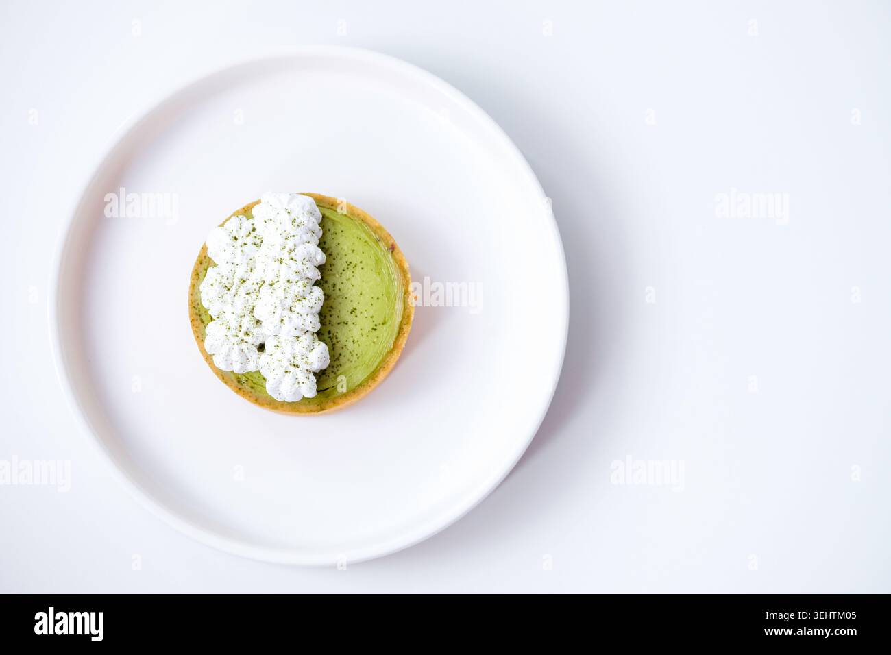 Matcha cheese tart on a white plate Stock Photo - Alamy