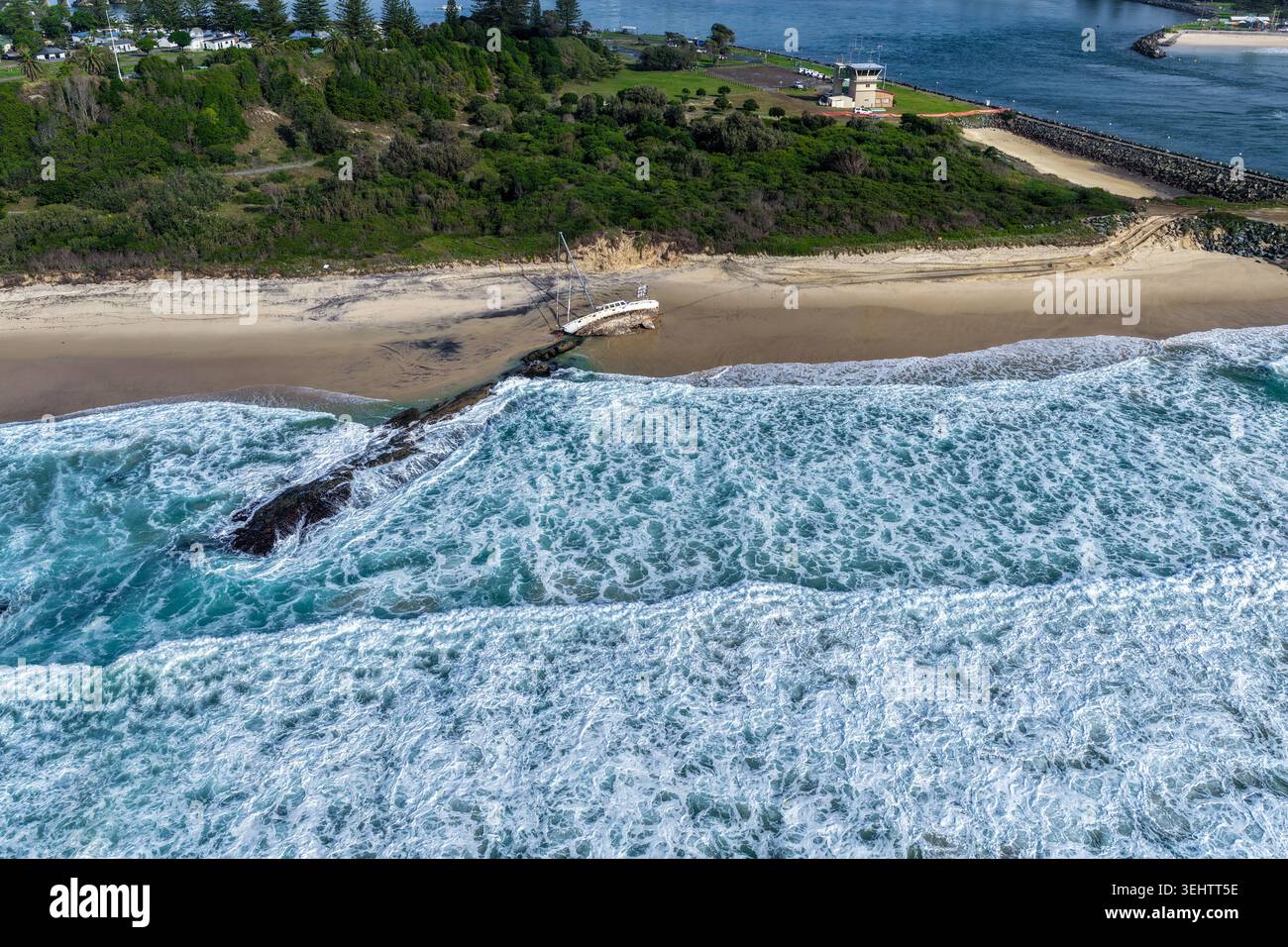 Aerial view of a stranded sailboat resting on the sand at Forster Main ...