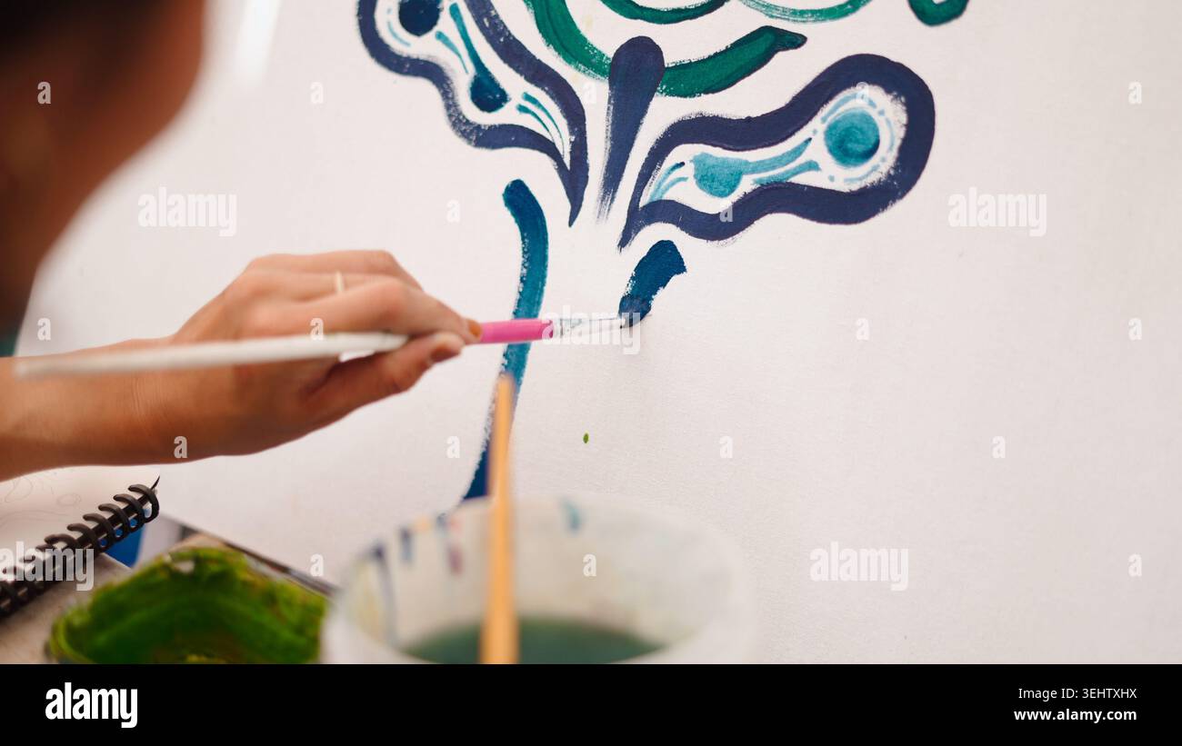 Artist hands brush painting abstract blue teal colors on canvas ...