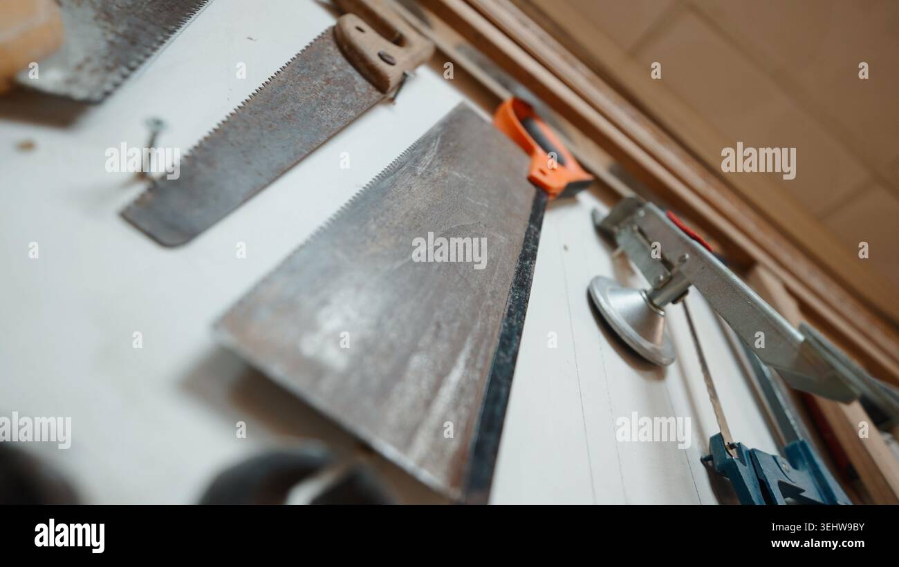 Artisan workshop displaying hand tools, saws, and clamps for carpentry ...