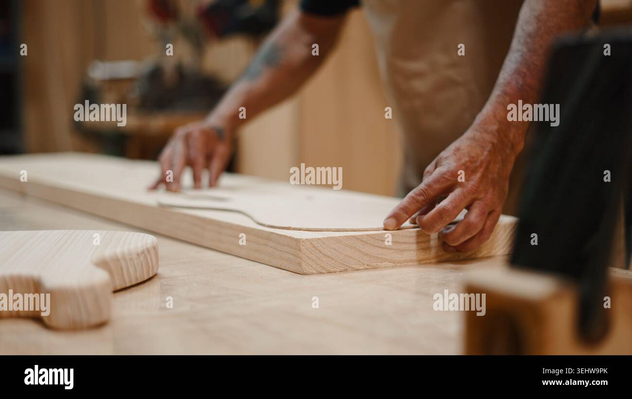 Wood artisan tracing design pattern on timber, crafting custom wooden ...