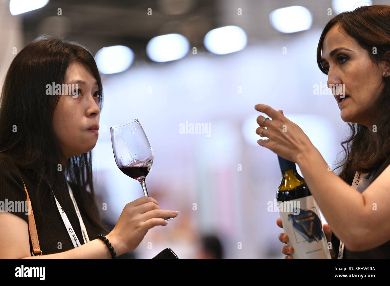 A general view showing a lady drinking wine at Vinexpo Asia in Hong ...