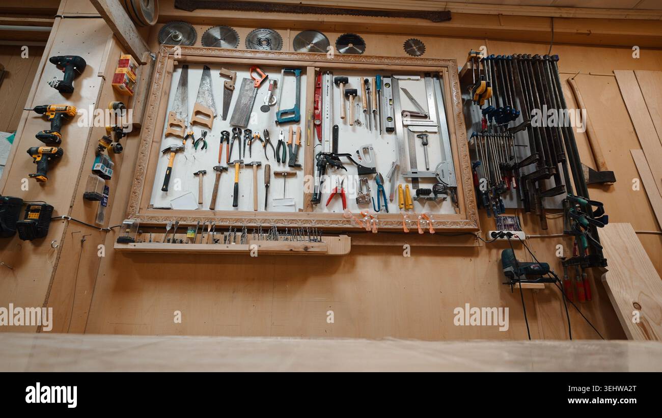 Woodworking workshop wall displaying tools and equipment for carpentry ...