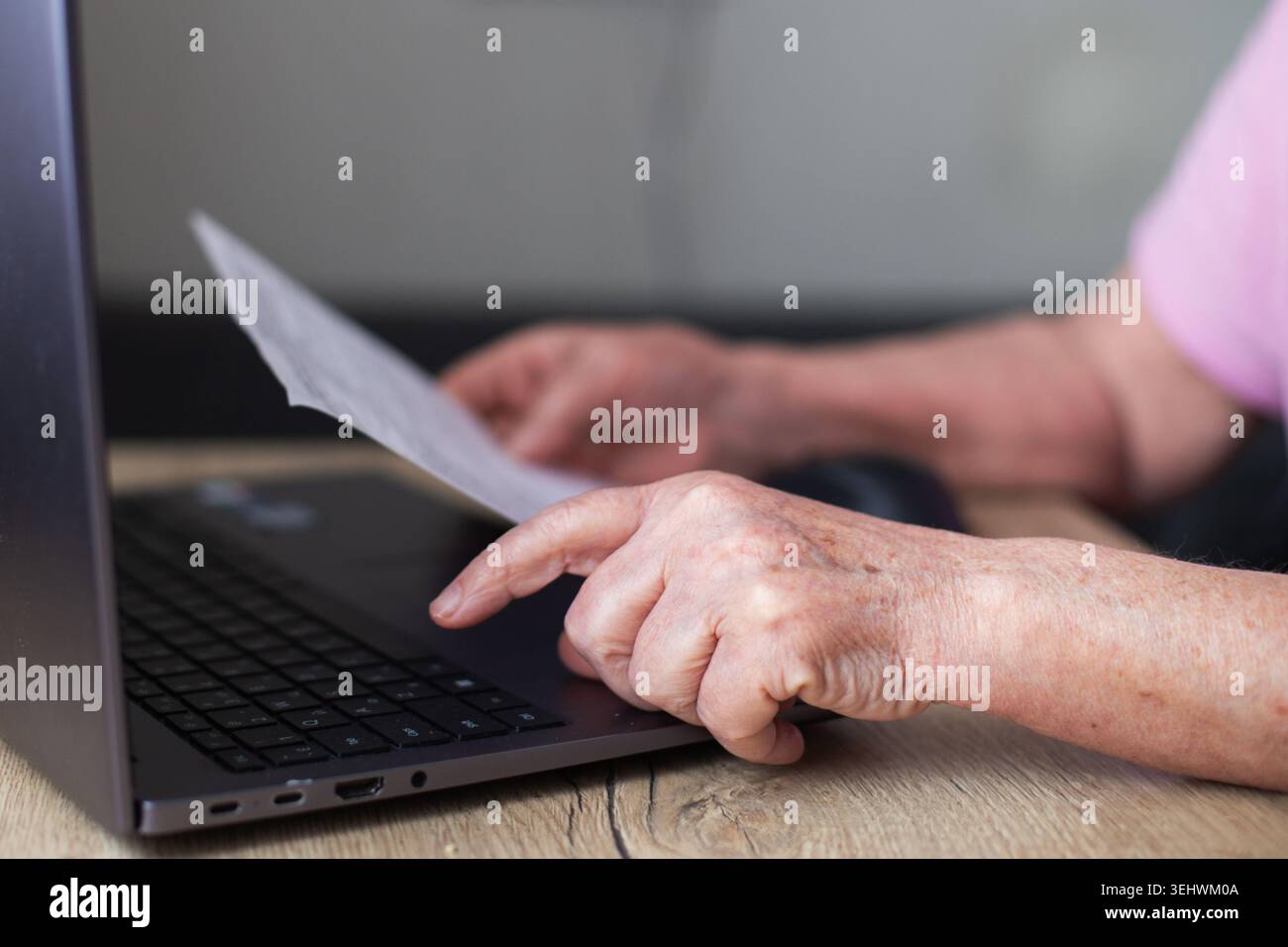 Senior woman doing online banking, paying domestic utility bills at ...