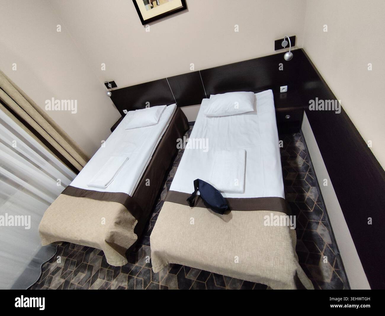 Simple standard hotel room interior featuring two single twin beds ...