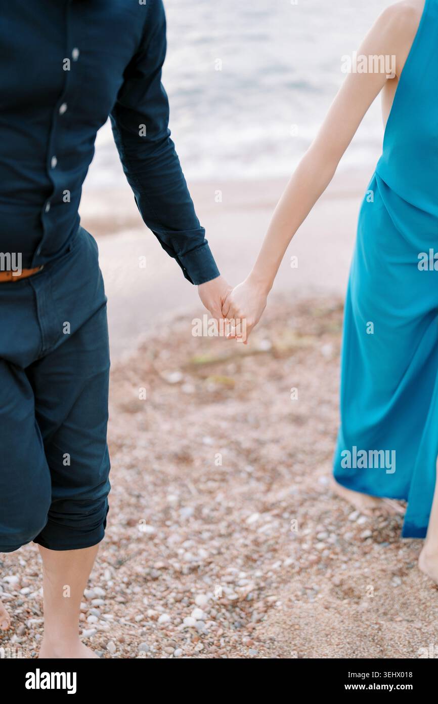 Walking Hand in Hand. Romantic engagement photo with flowing dress and ...