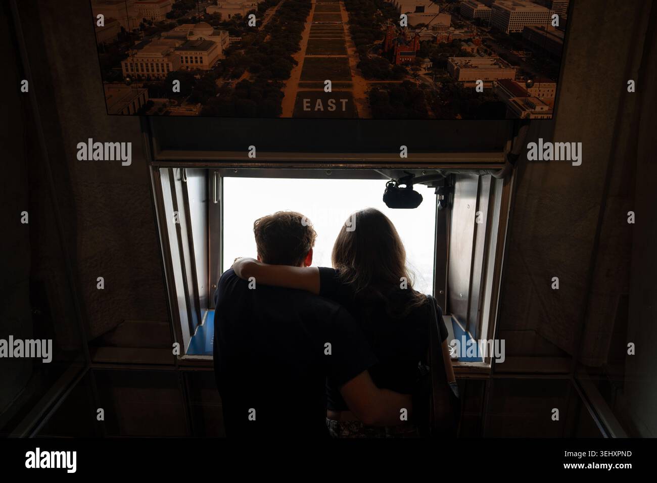 A couple embrace as they look out the east side of the Washington ...