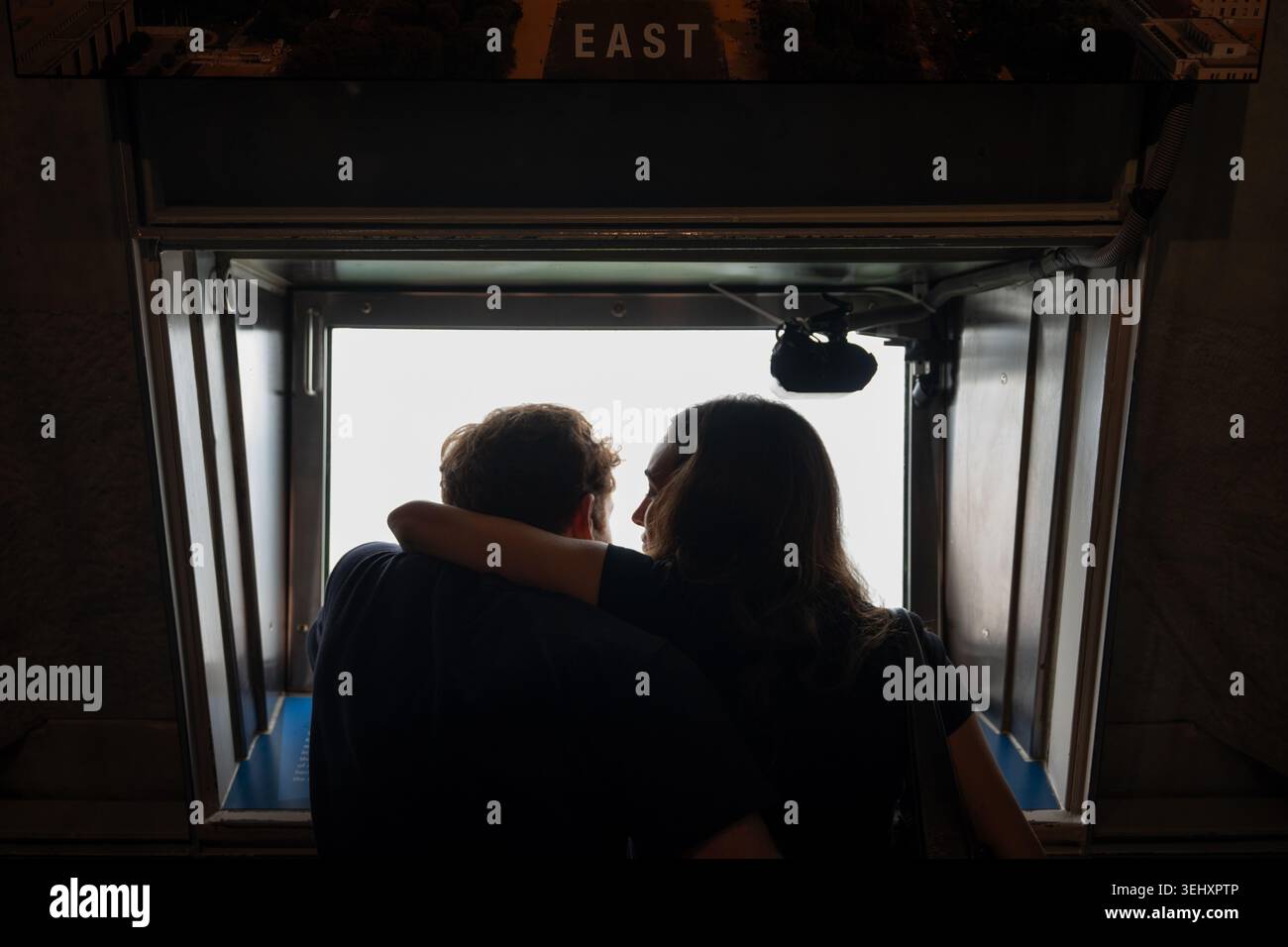 A couple embrace as they look out the east side of the Washington ...