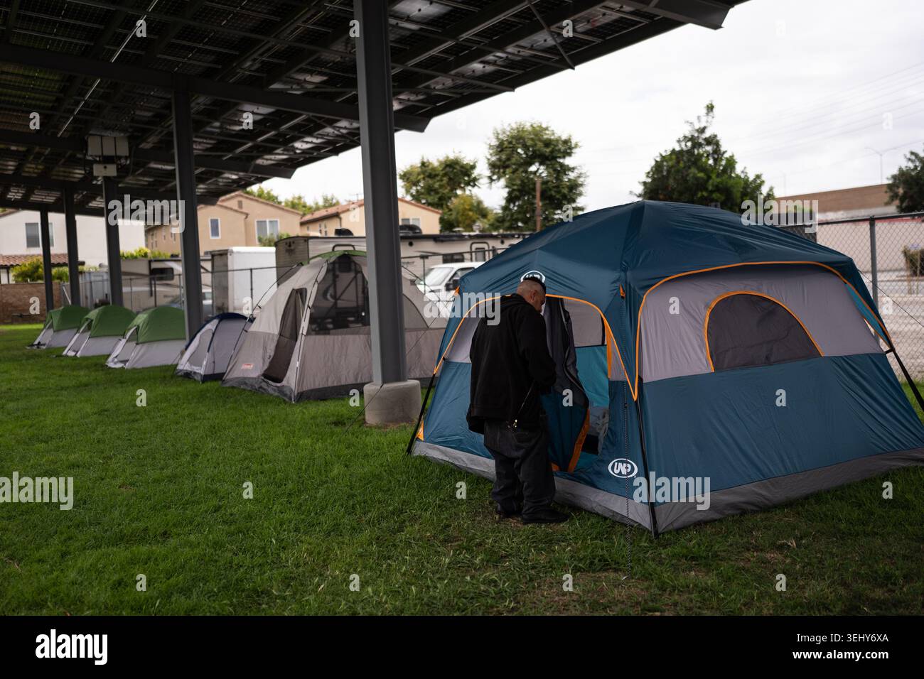 Evacuee Brandon McBride stands outside his tent at a shelter at the ...