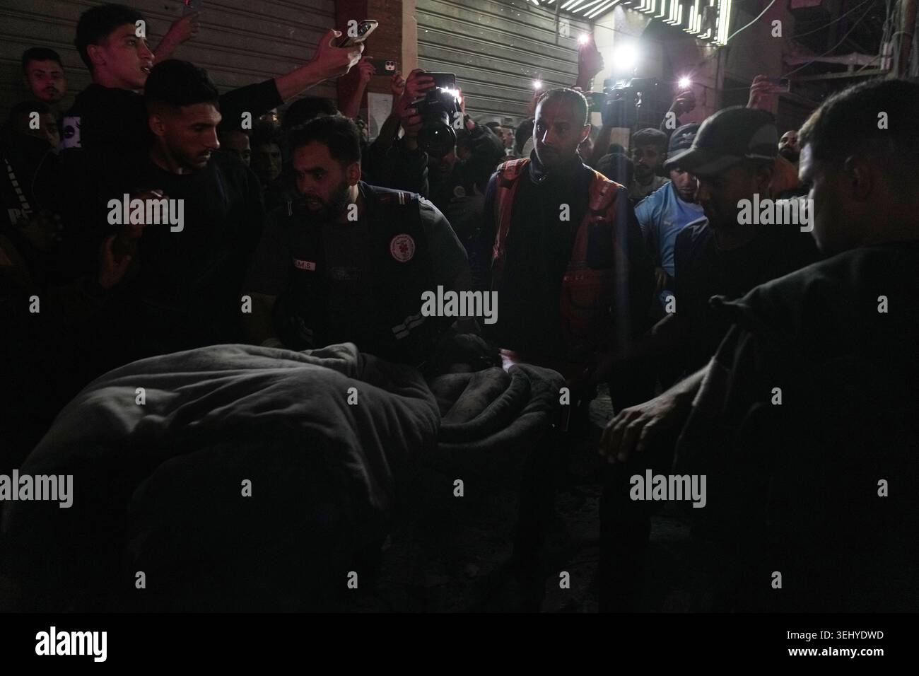 Palestinians carry a body from the site of an Israeli airstrike in Gaza ...