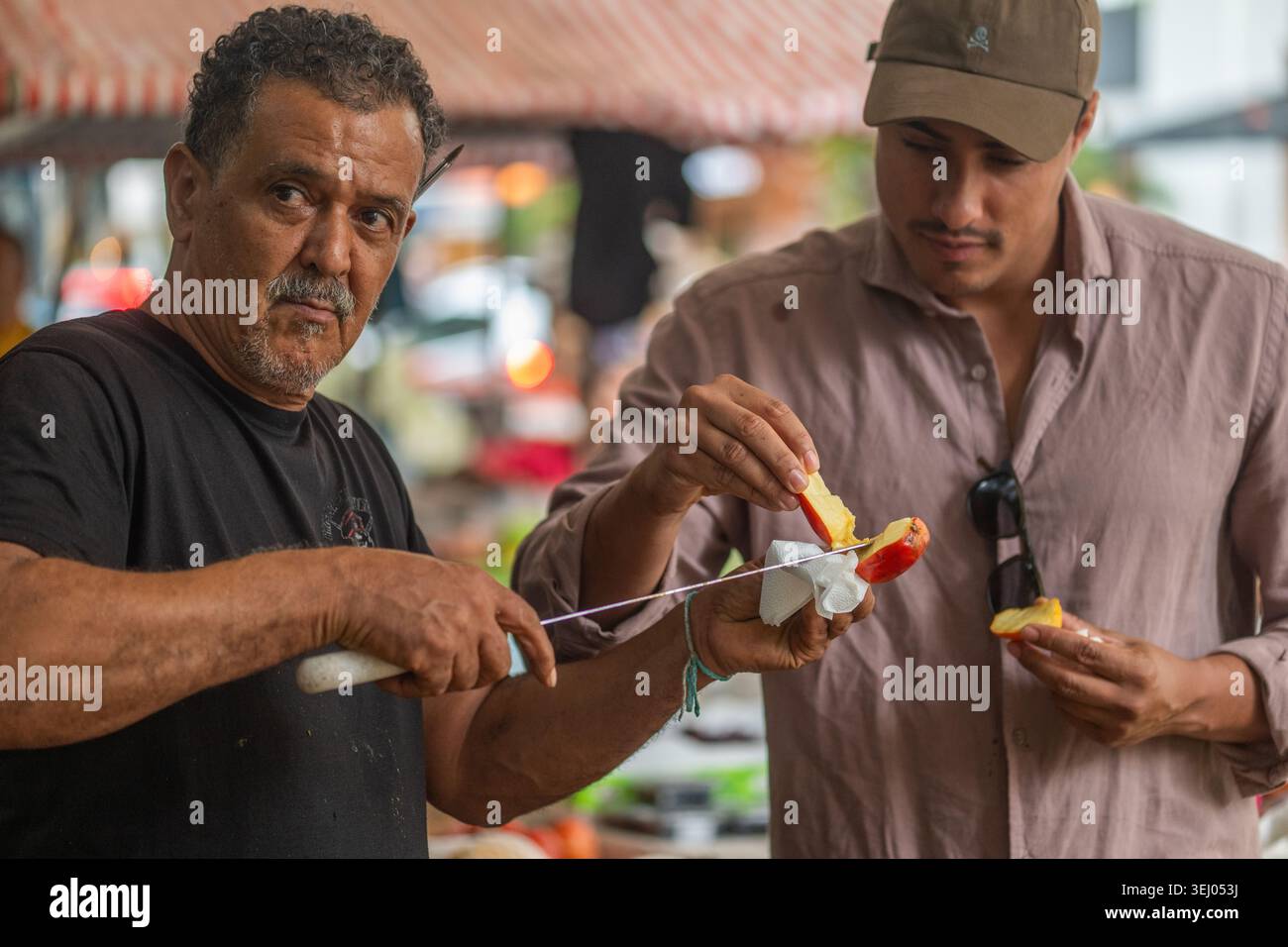 Rio de Janeiro, Brazil - 22 May 2026: View of a vendor cutting a slice ...