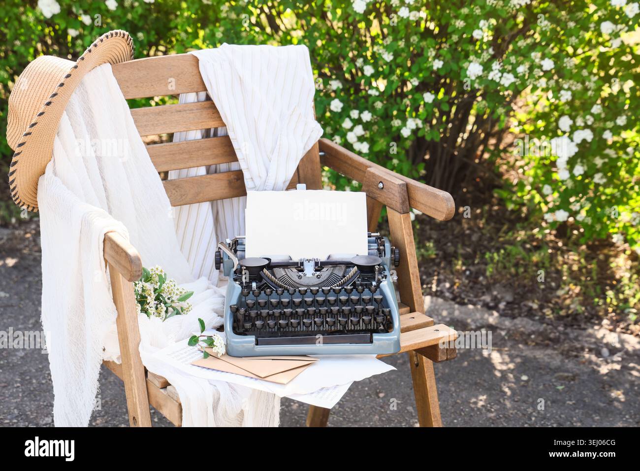 Chair with vintage typewriter and flowers in garden on spring day Stock ...