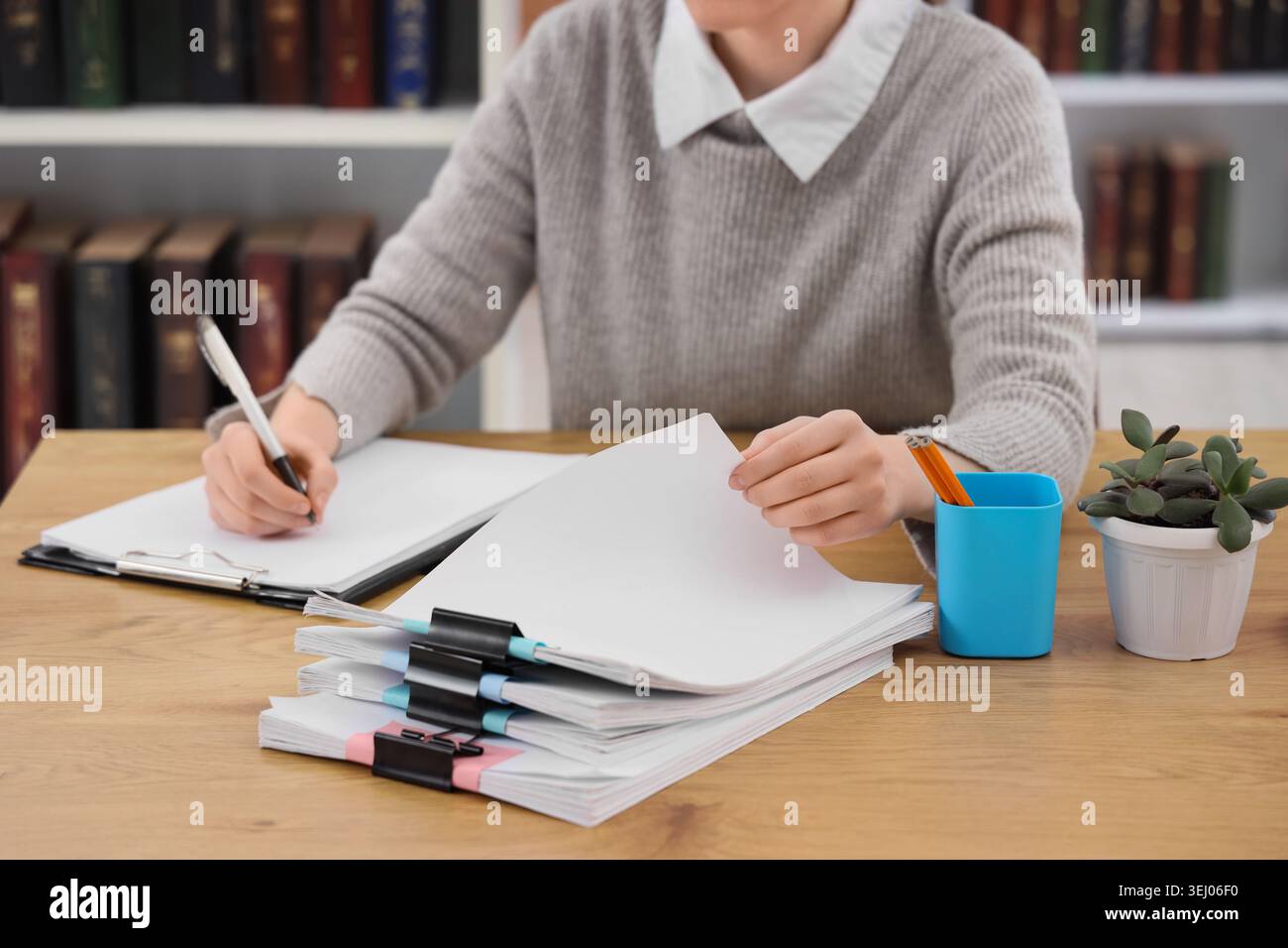 Woman working with documents at desk in office Stock Photo - Alamy