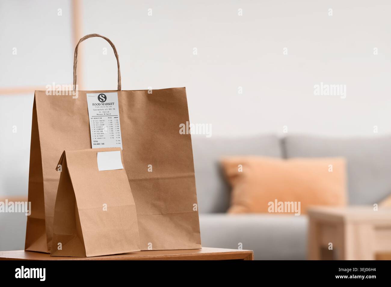 Paper bags on table in room. Food delivery service Stock Photo - Alamy