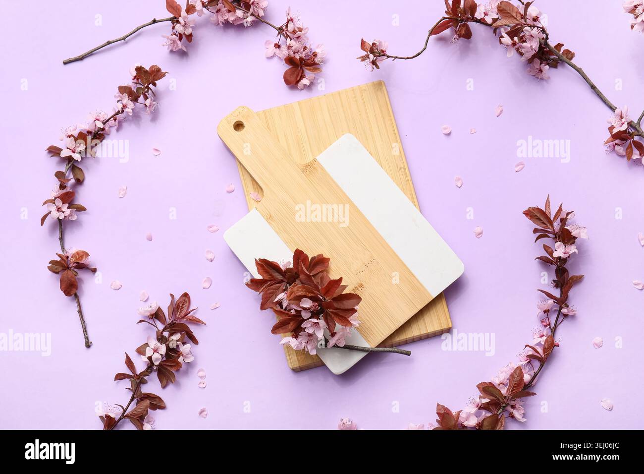 Different wooden cutting boards with beautiful blooming tree branches ...