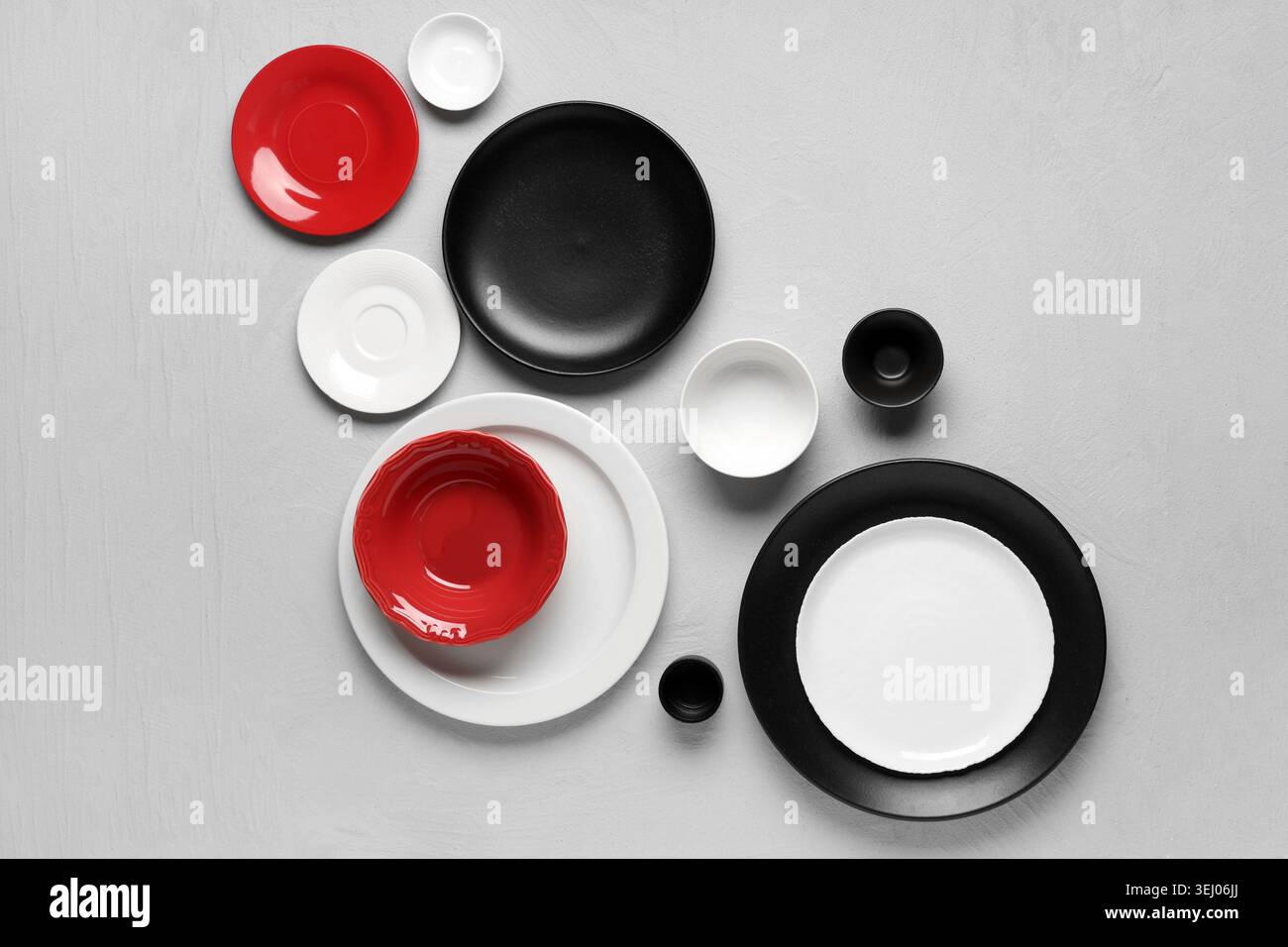 Different plates with bowls on white grunge background Stock Photo - Alamy