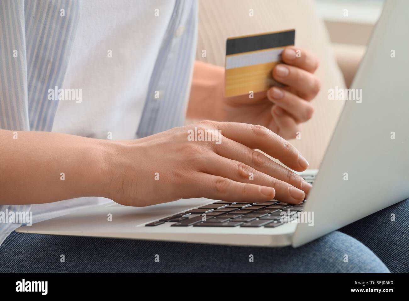 Woman with credit card using laptop at home, closeup Stock Photo - Alamy
