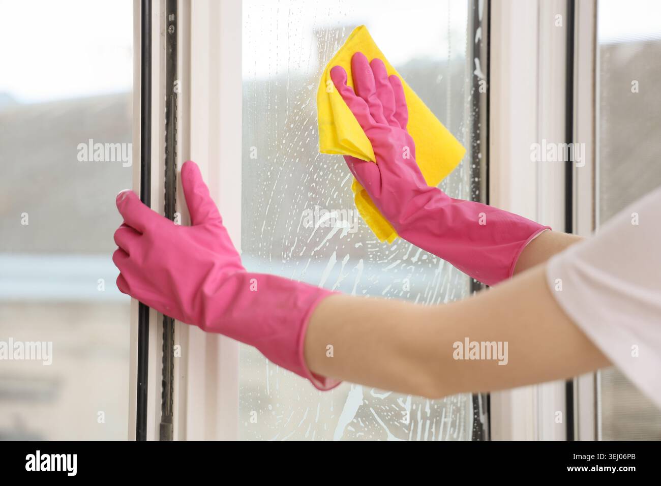 Female hands with rag washing window in room Stock Photo - Alamy