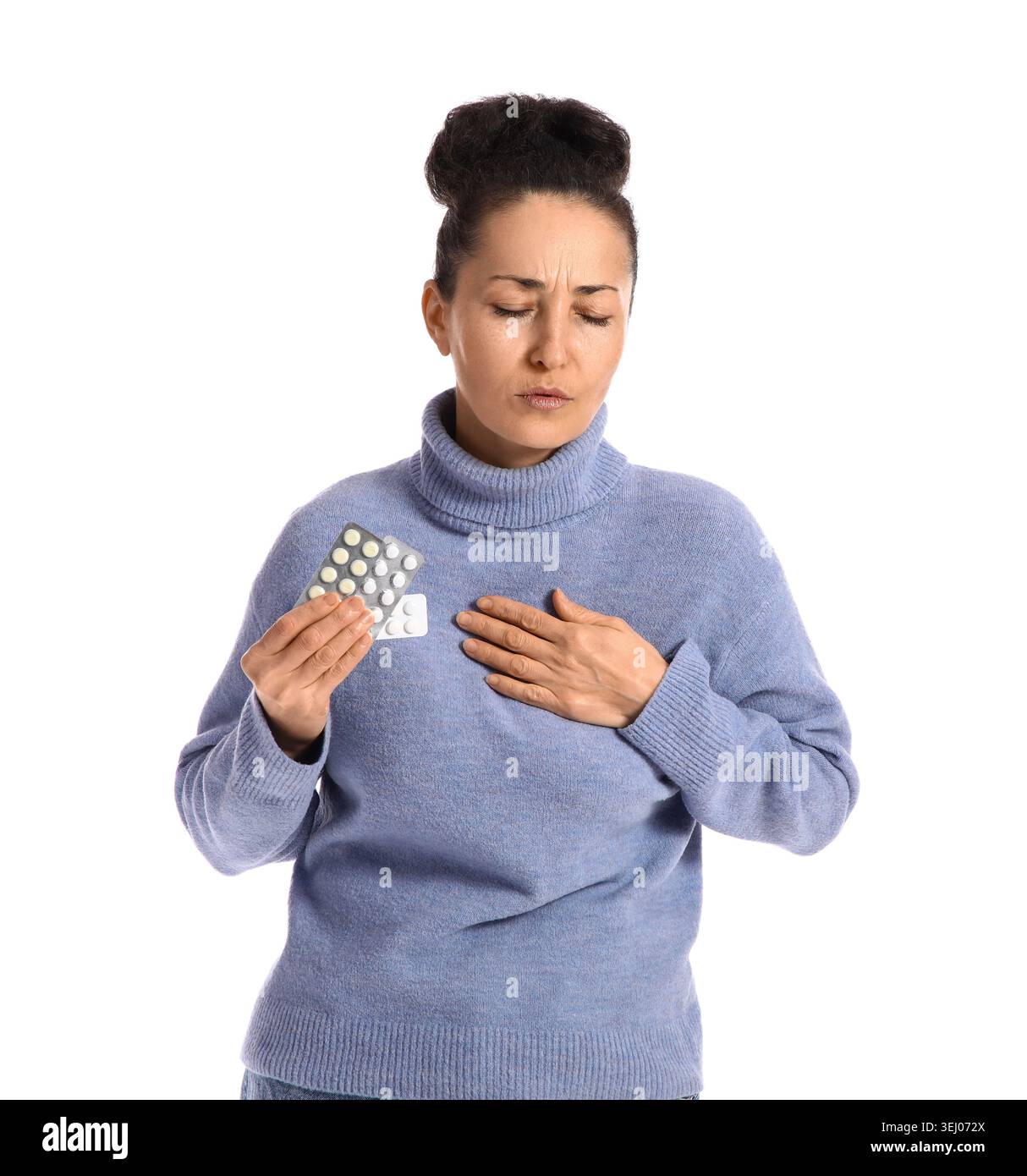 Mature woman with pills having heart attack on white background Stock ...