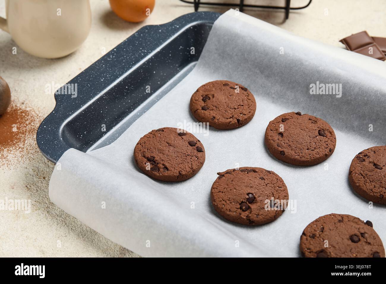 Baking tray with chocolate cookies on light background Stock Photo - Alamy