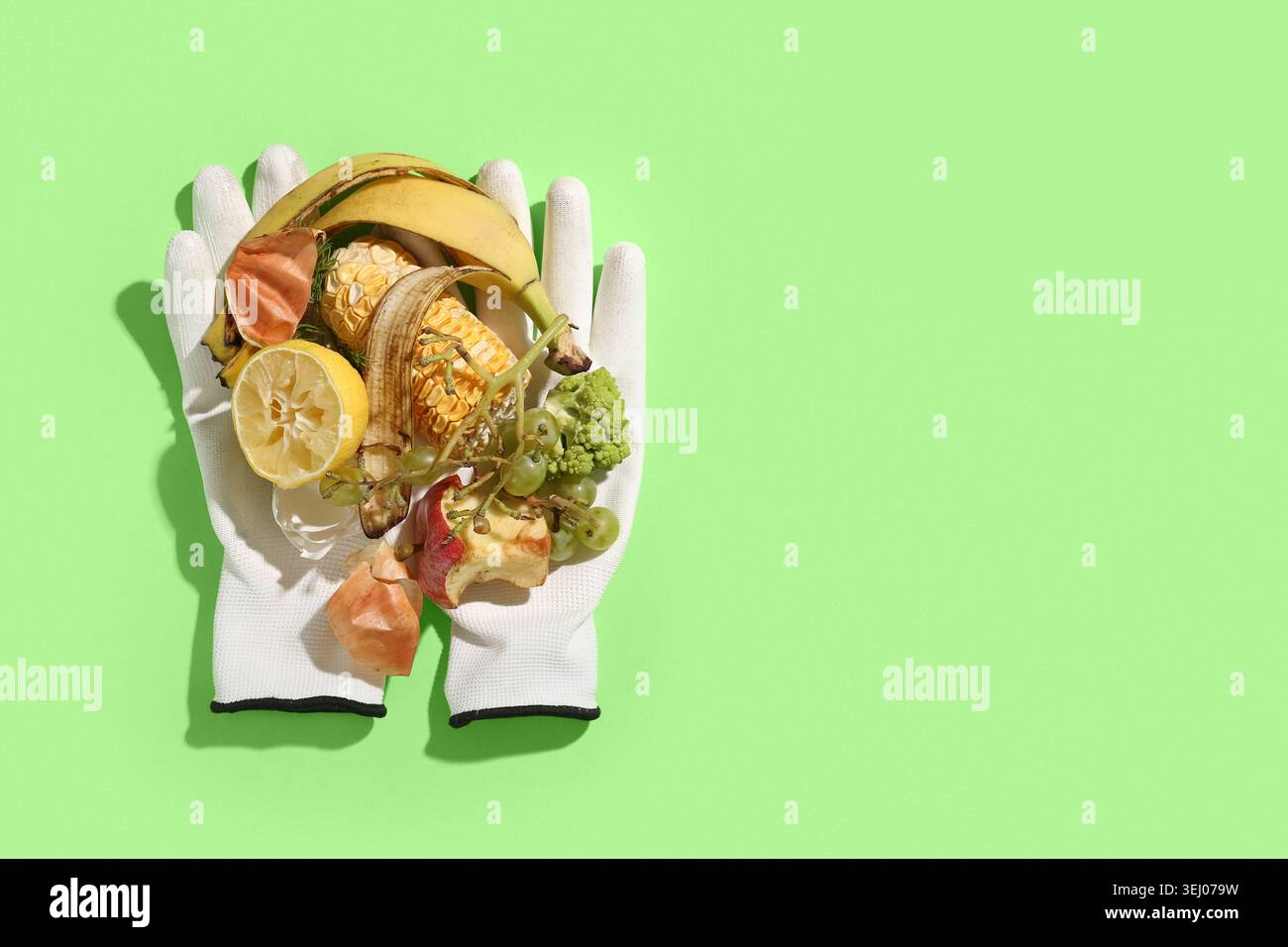 Different organic waste with gloves on green background. Compost ...