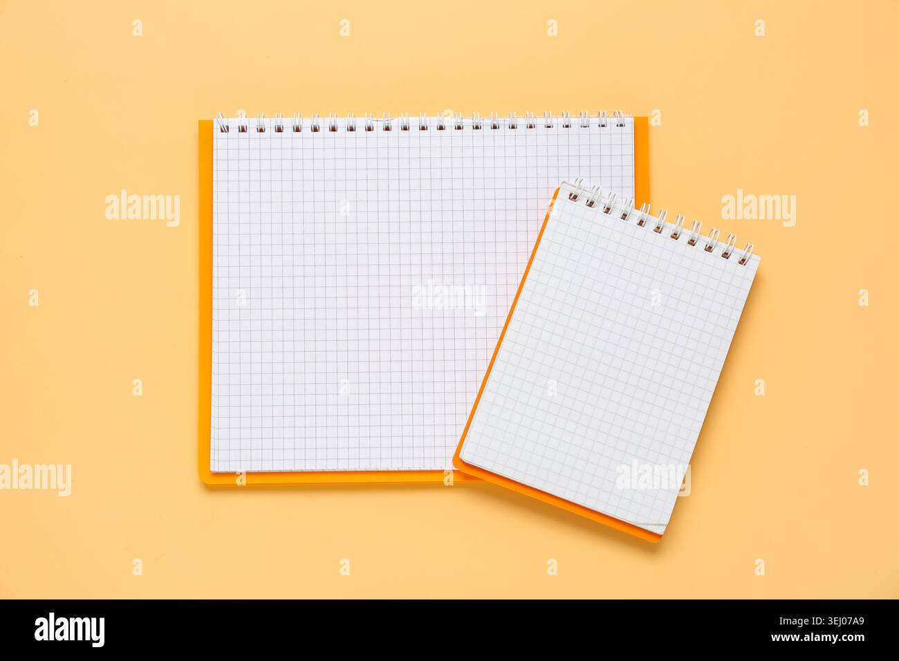 Blank notebooks on orange background Stock Photo - Alamy