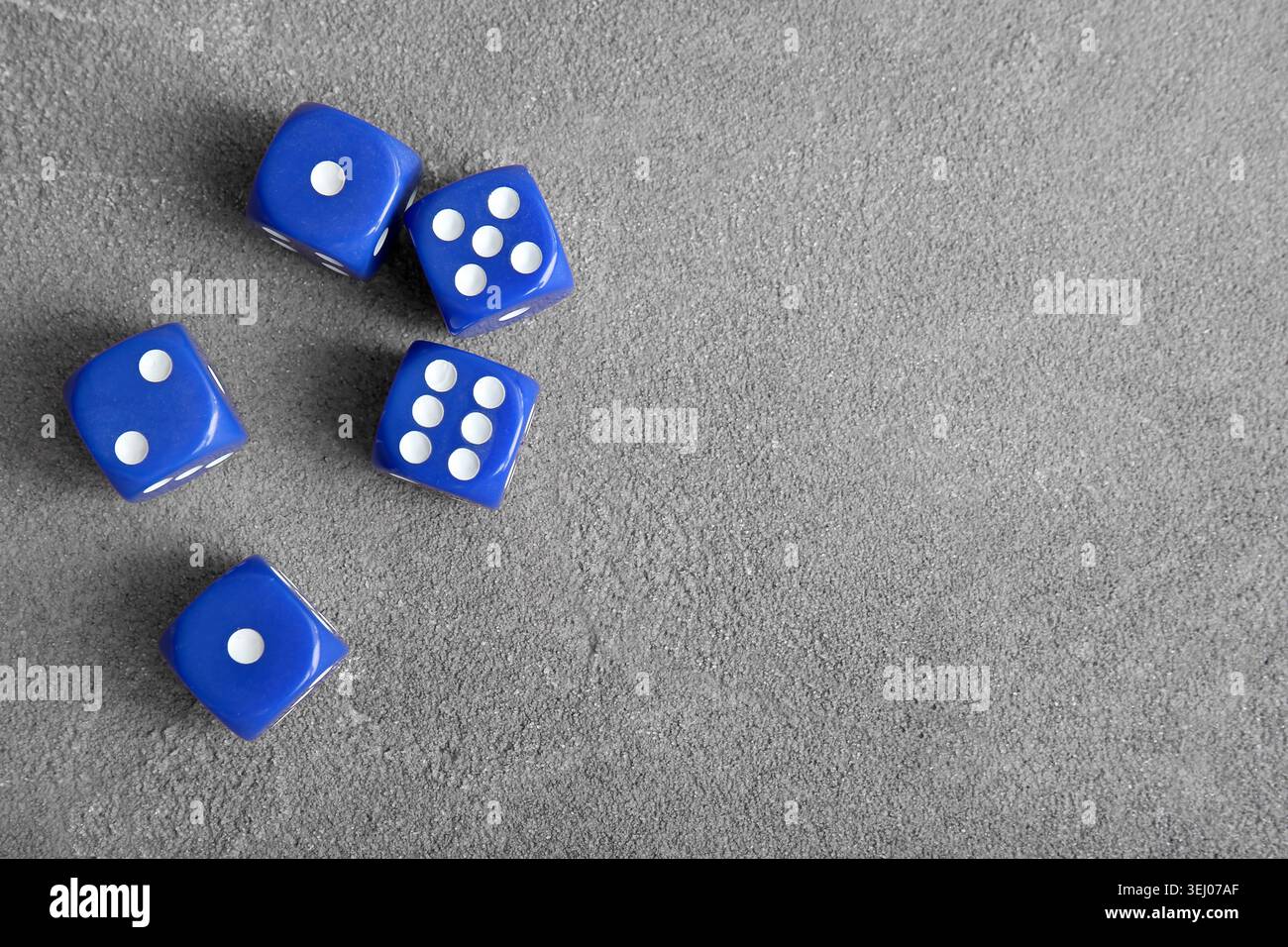 Blue dices on grey background Stock Photo - Alamy