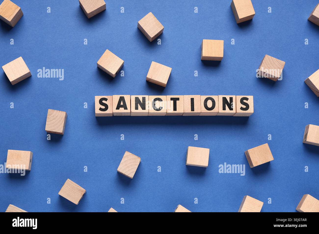 Cubes with word SANCTIONS on blue background Stock Photo - Alamy