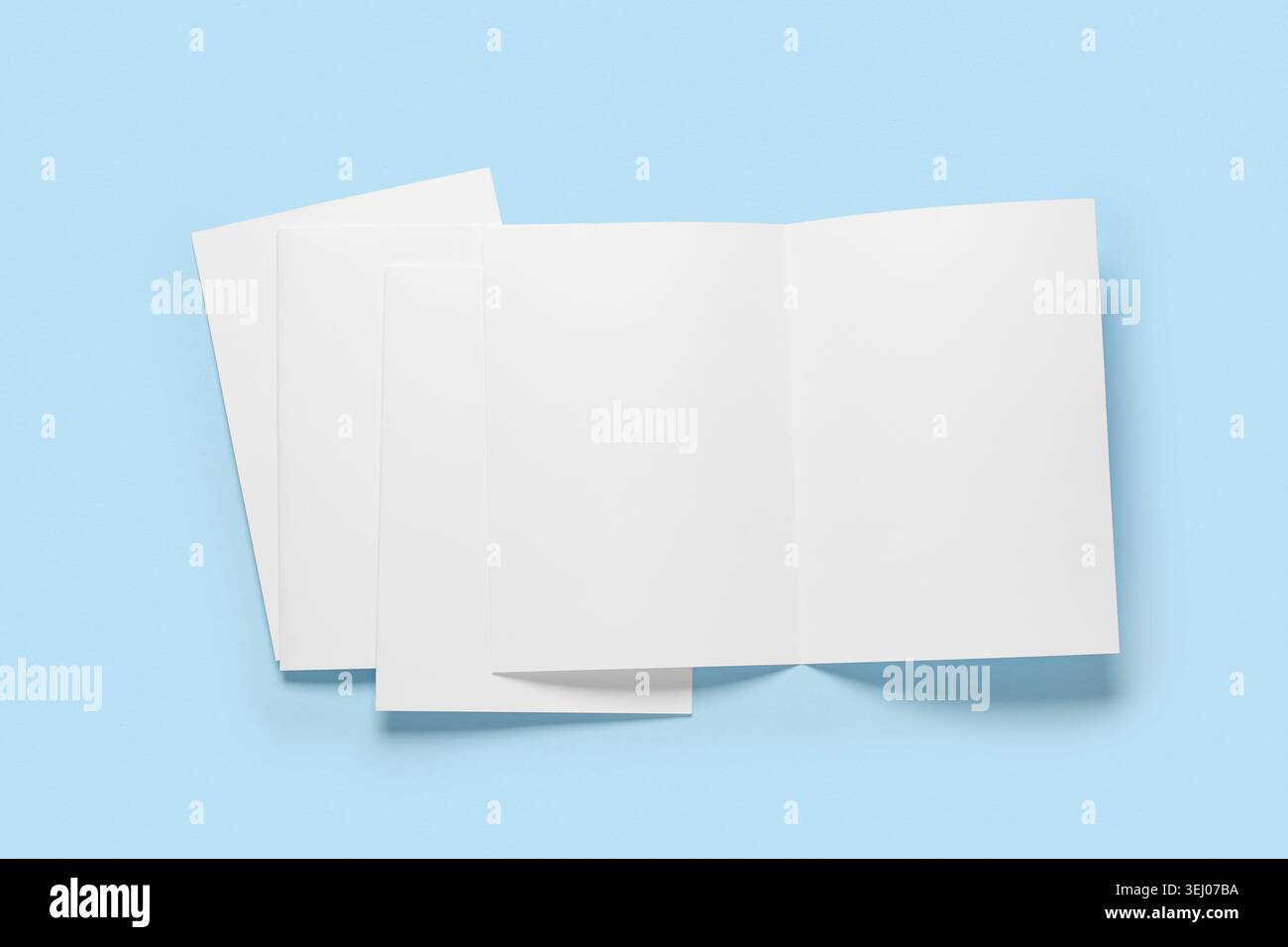 Blank brochures on blue background Stock Photo - Alamy