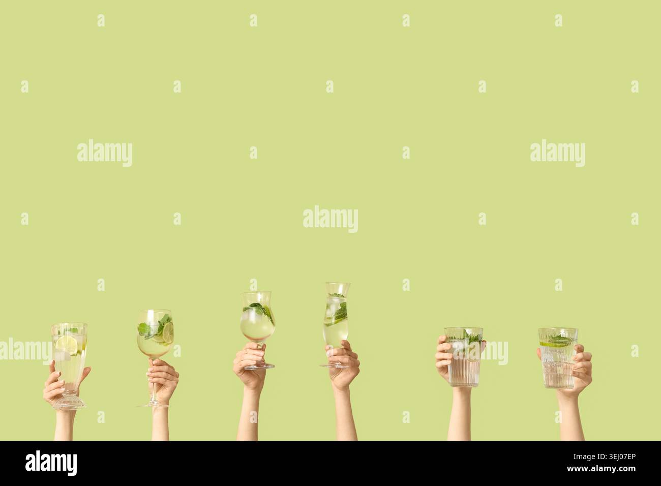 Female hands with different glasses of mojito on green background Stock ...