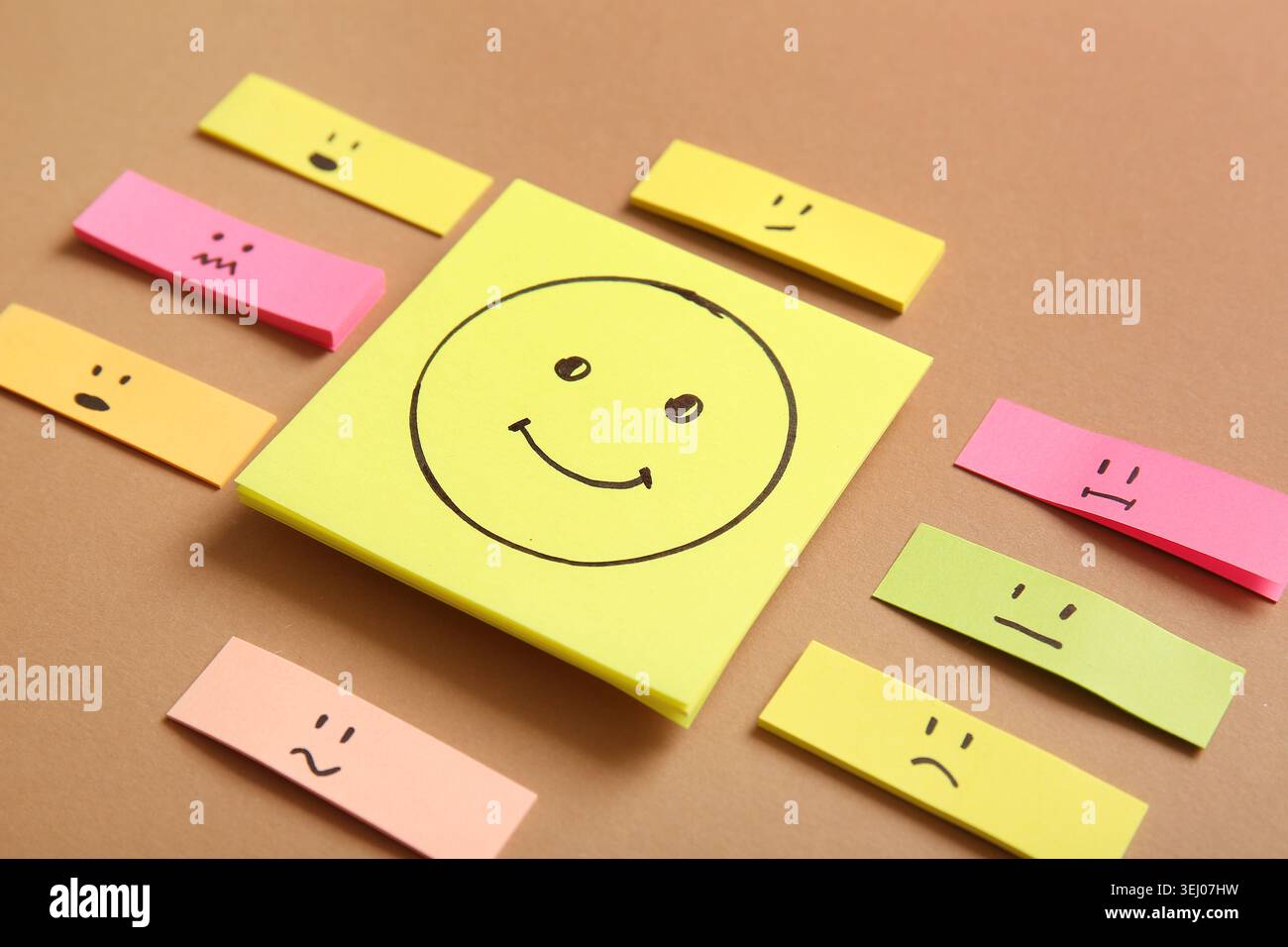 Sticky papers with drawings of different emotion faces on brown ...