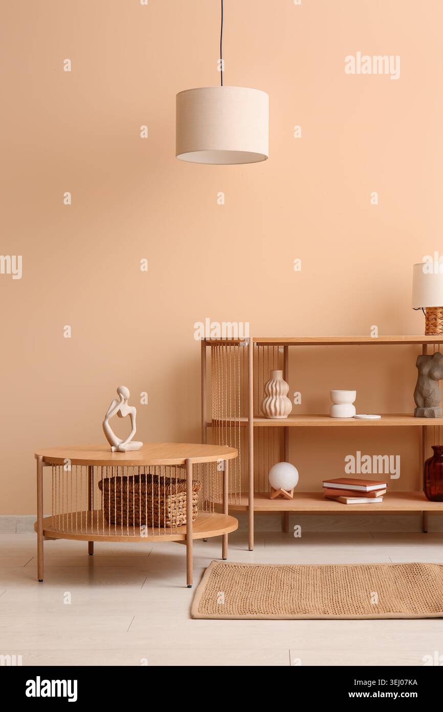 Shelving unit with wooden table and hanging lamp in modern room Stock ...