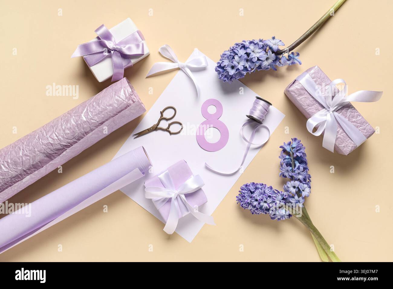 Figure 8 with lilac flowers, gift boxes and wrapping paper on beige ...