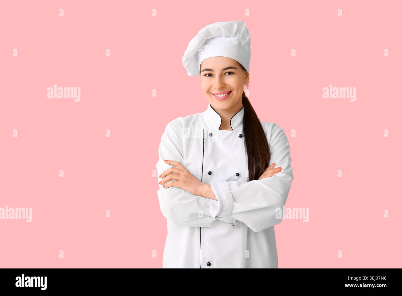 Young female chef on pink background Stock Photo - Alamy