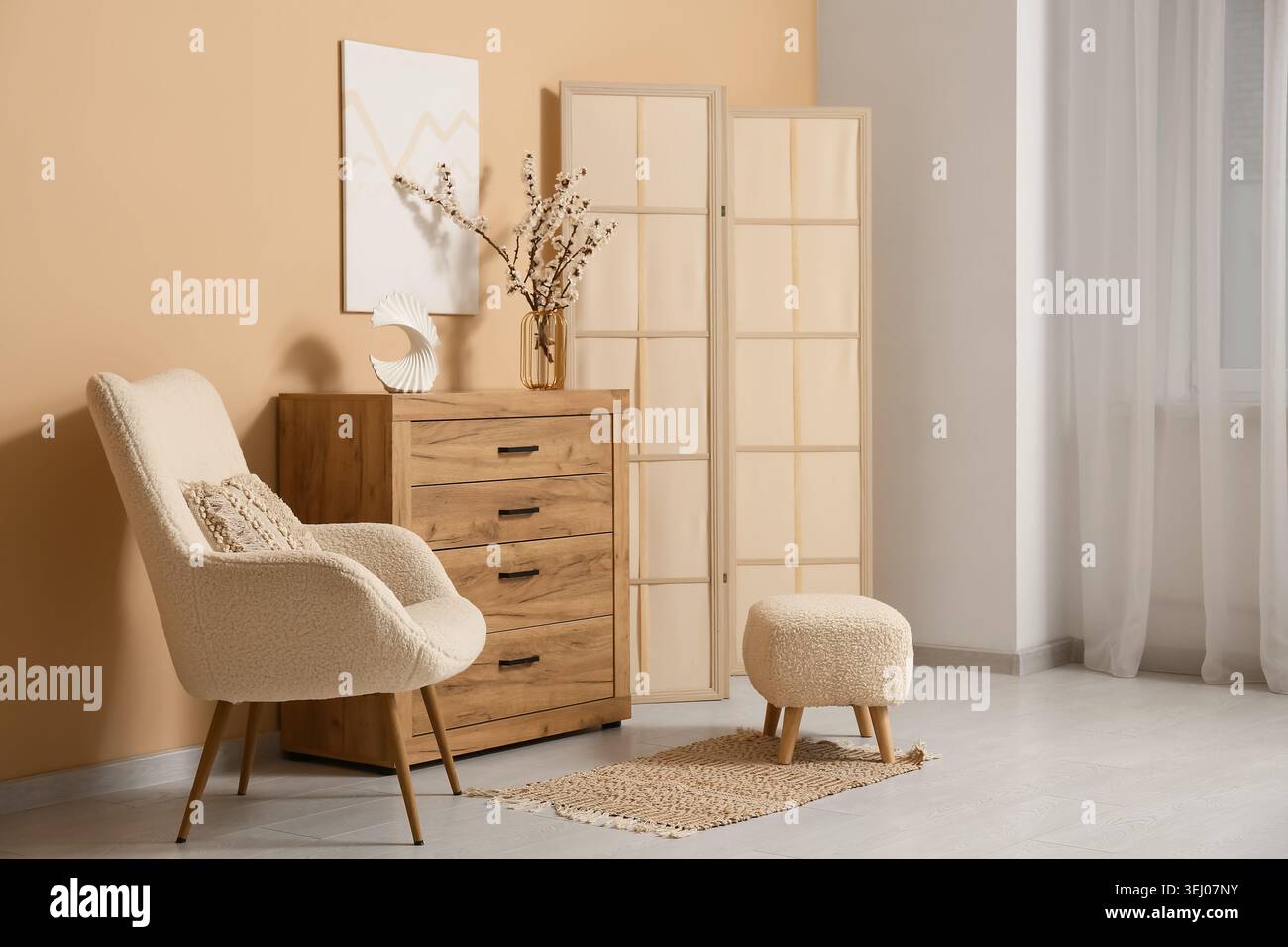 Interior of room with armchair, chest of drawers, folding screen and ...