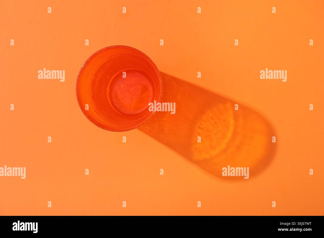 Empty glass on orange background Stock Photo - Alamy