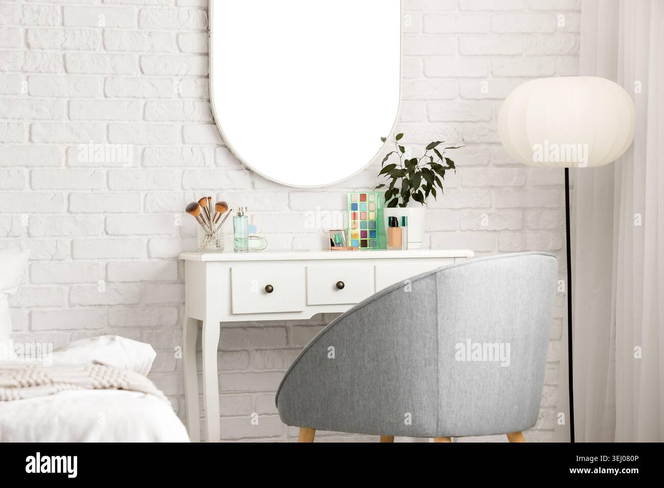 Dressing table with mirror, cosmetic products and perfumes near white ...