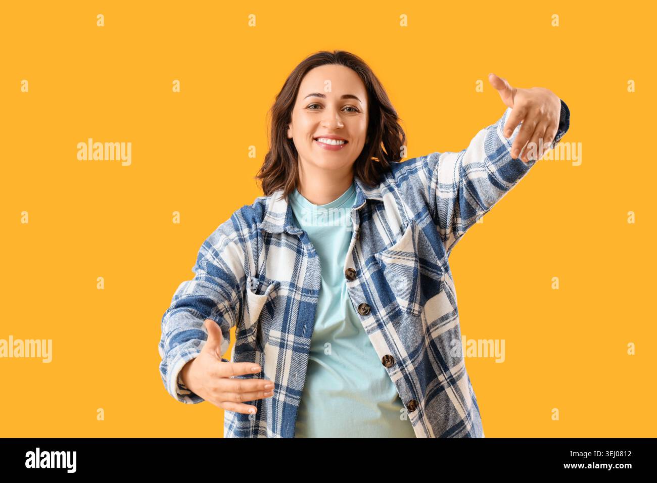 Young pregnant woman opening arms for hug on yellow background. Rules ...
